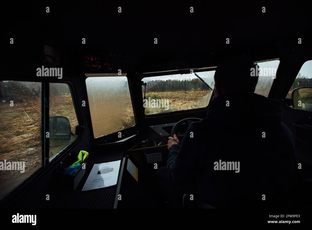 the driver is driving off-road. view from the interior of a four-wheel ...