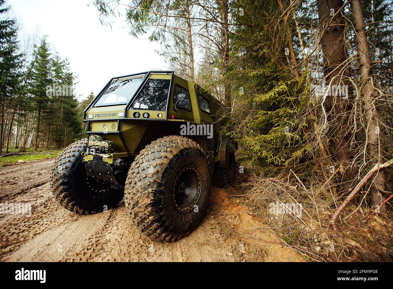 a four-wheel drive all-terrain vehicle drives through the forest ...
