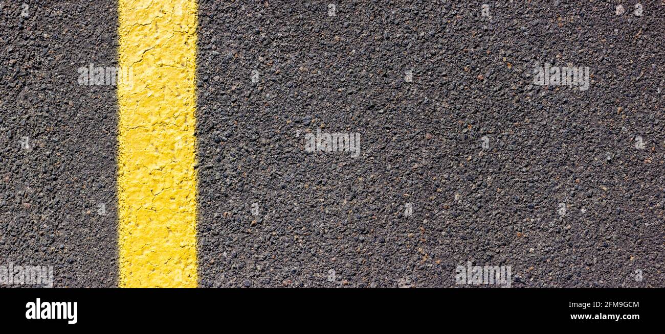 Asphalt texture with a yellow line on the left side. Road surface with ...
