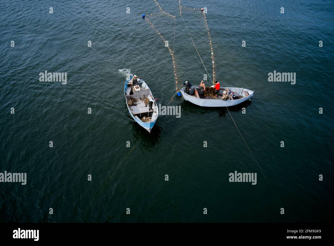 Fishing boats floating on the sea Stock Photo - Alamy