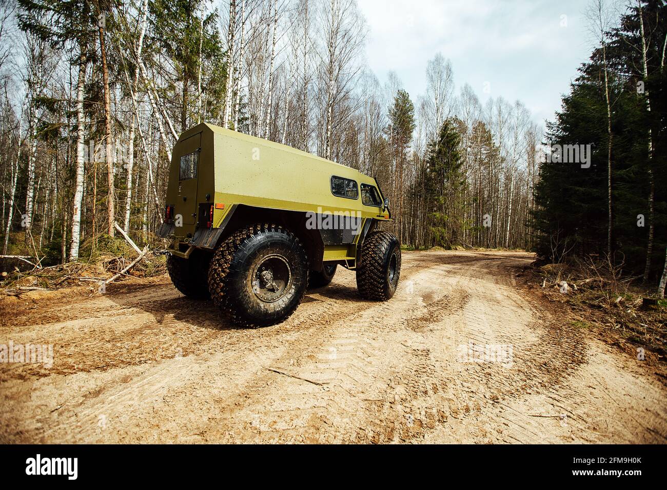 a four-wheel drive all-terrain vehicle drives through the forest ...
