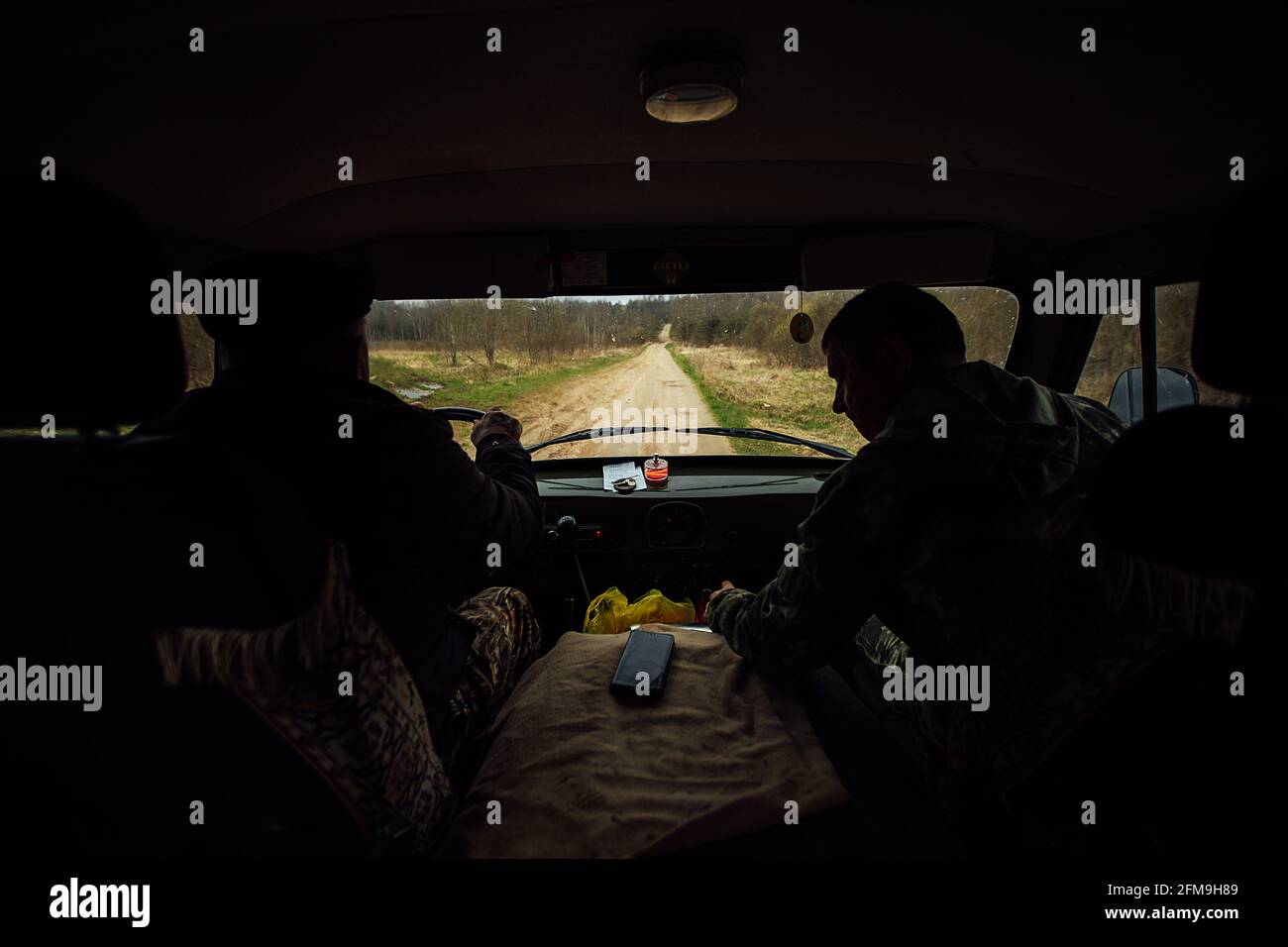 the driver is driving off-road. view from the interior of a four-wheel ...