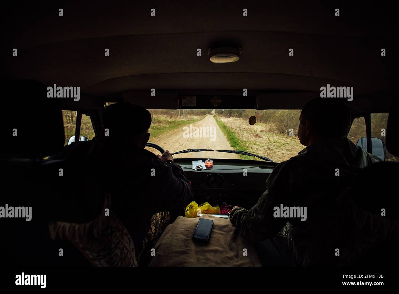 the driver is driving off-road. view from the interior of a four-wheel ...