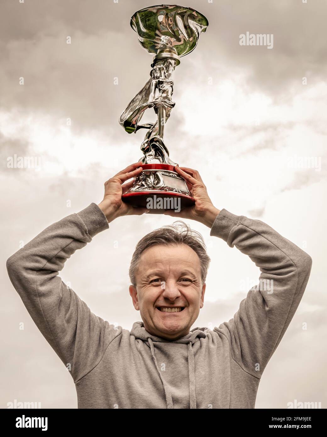 Man raising golden trophy hi-res stock photography and images - Alamy