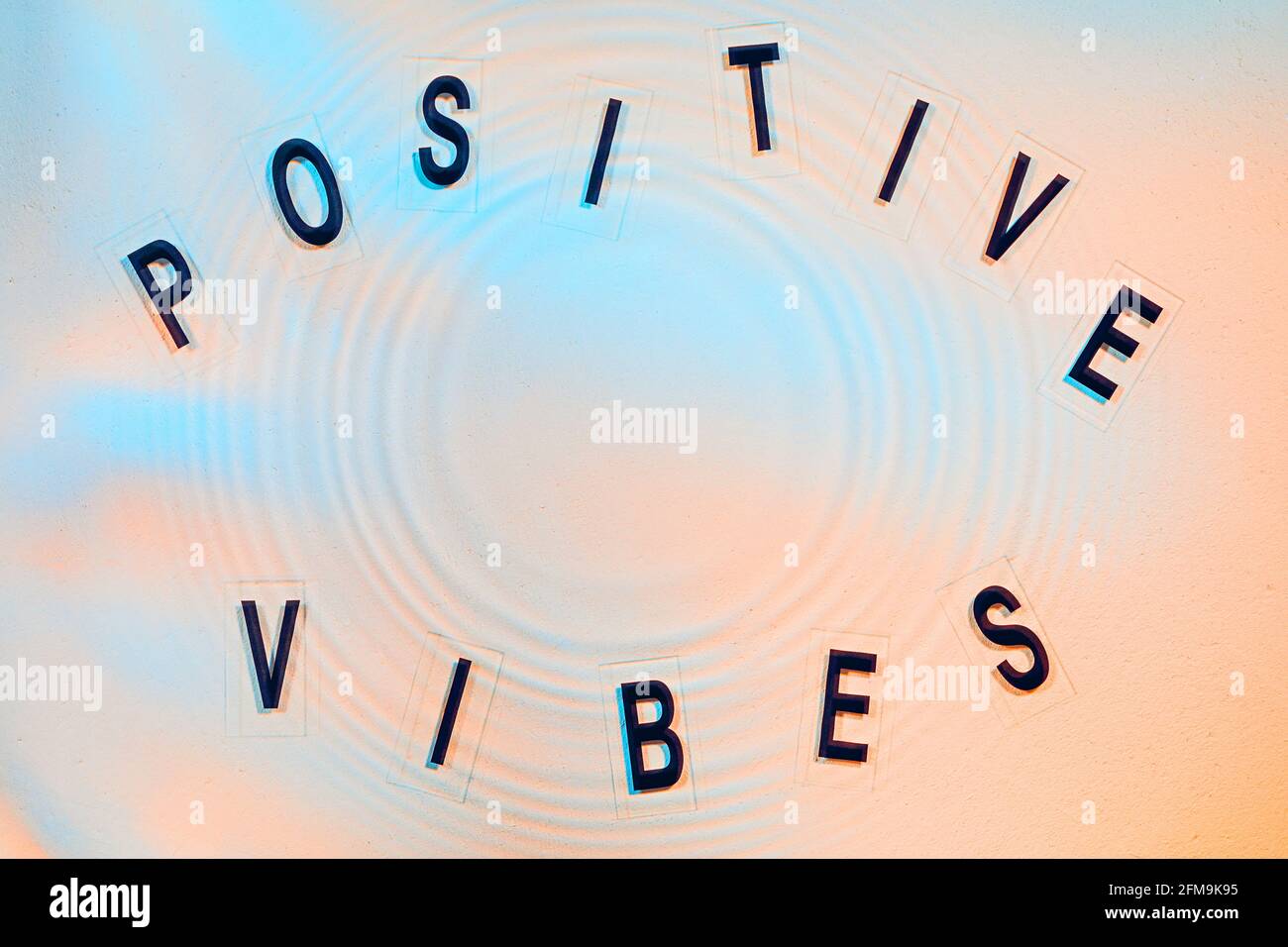Positive vibes. Text in multicolored light. Letters in the water Stock ...