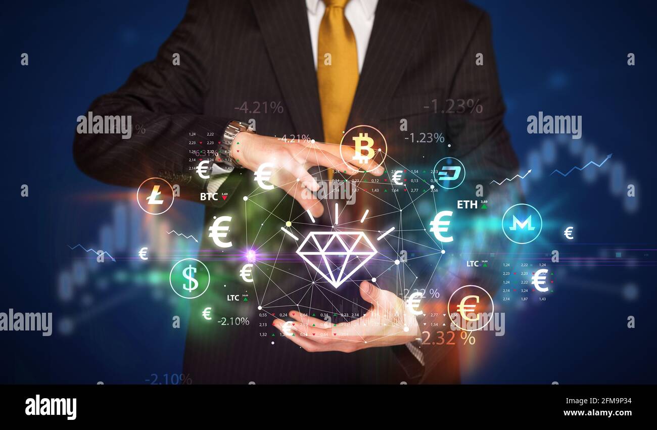 Businessman holding currency symbols concept Stock Photo - Alamy