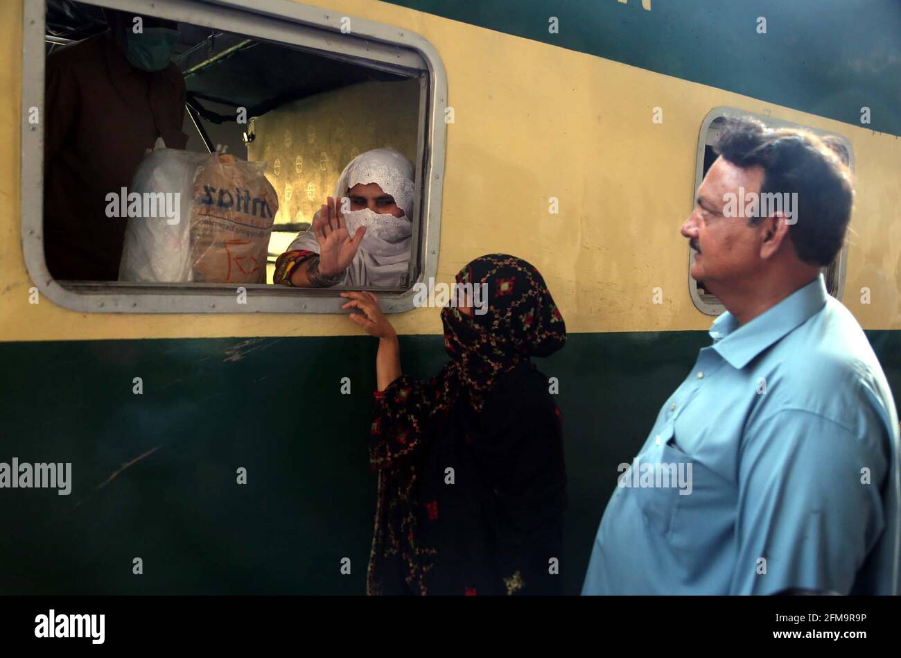 KARACHI, PAKISTAN, MAY 07: People to board on special Eid train as they ...