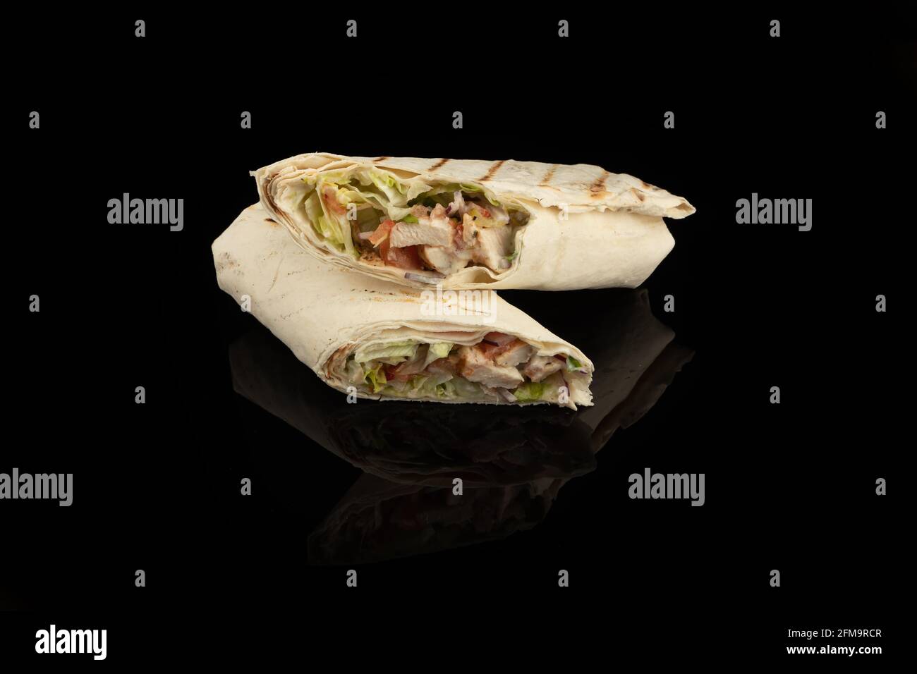 Classic shawarma kebab pita with chicken and vegetables and sauce on a ...
