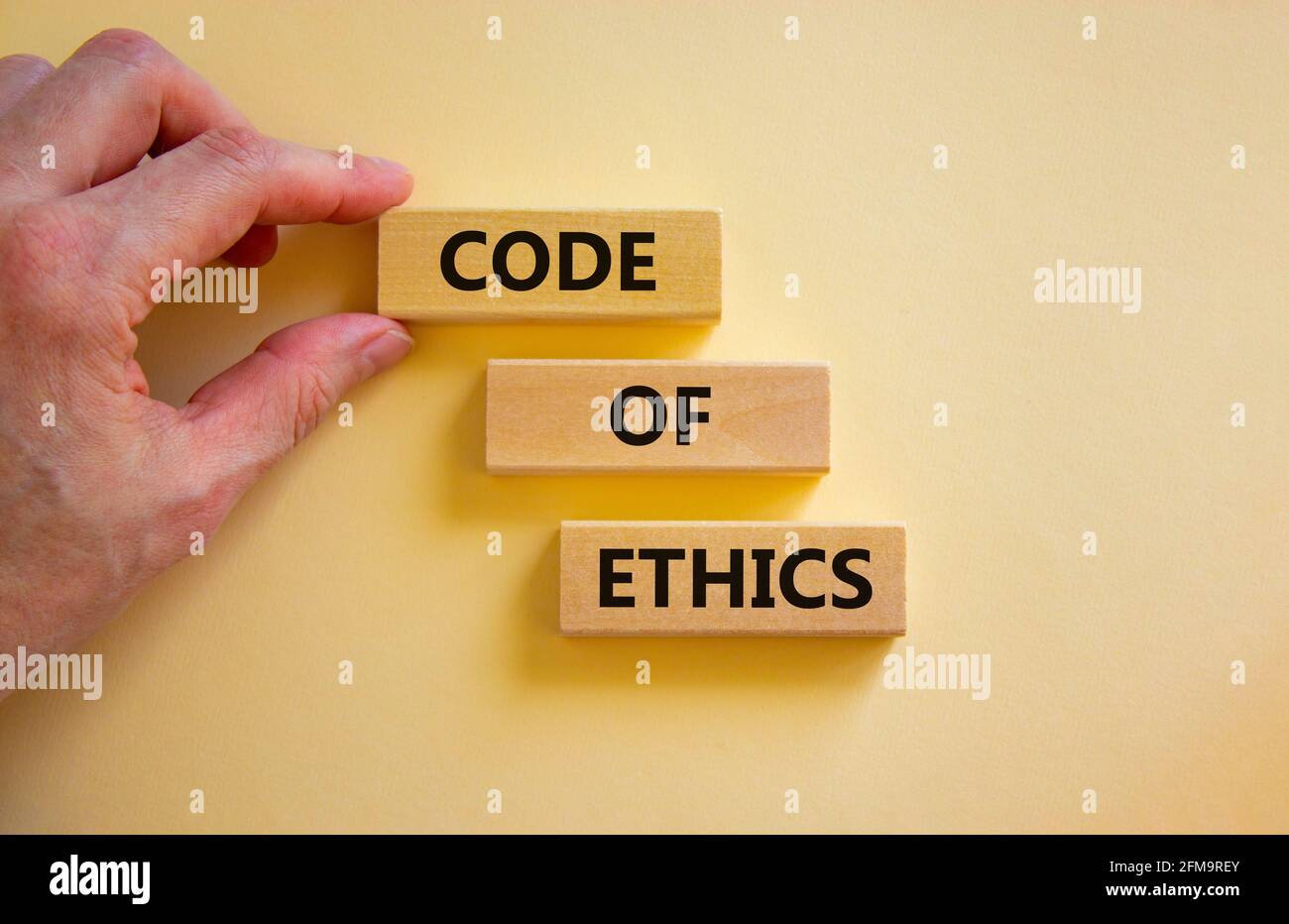 Code of ethics symbol. Wooden blocks with words 'Code of ethics ...