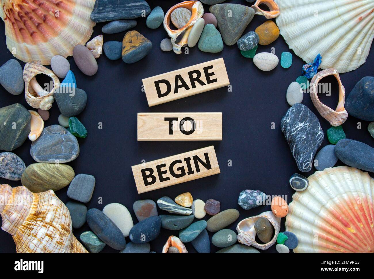 Dare to begin symbol. Wooden blocks with words 'Dare to begin ...