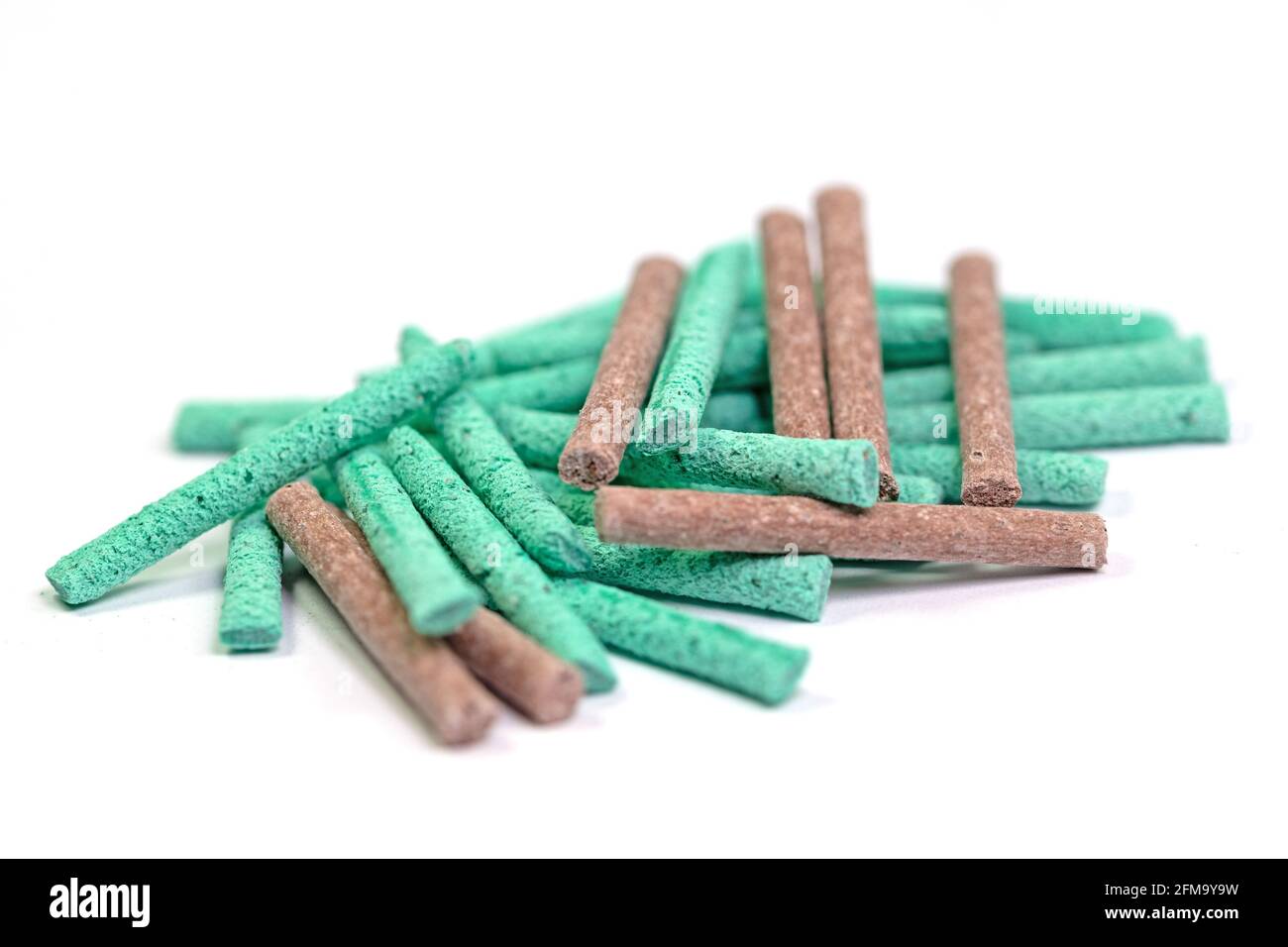 Fertilizer sticks isolated against white background Stock Photo - Alamy