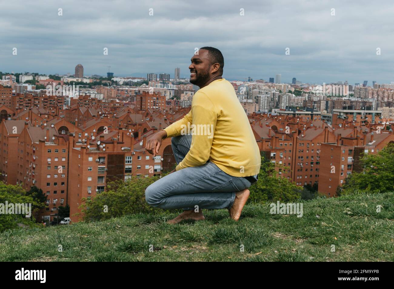 Black man looking at the horizon in a park Stock Photo - Alamy