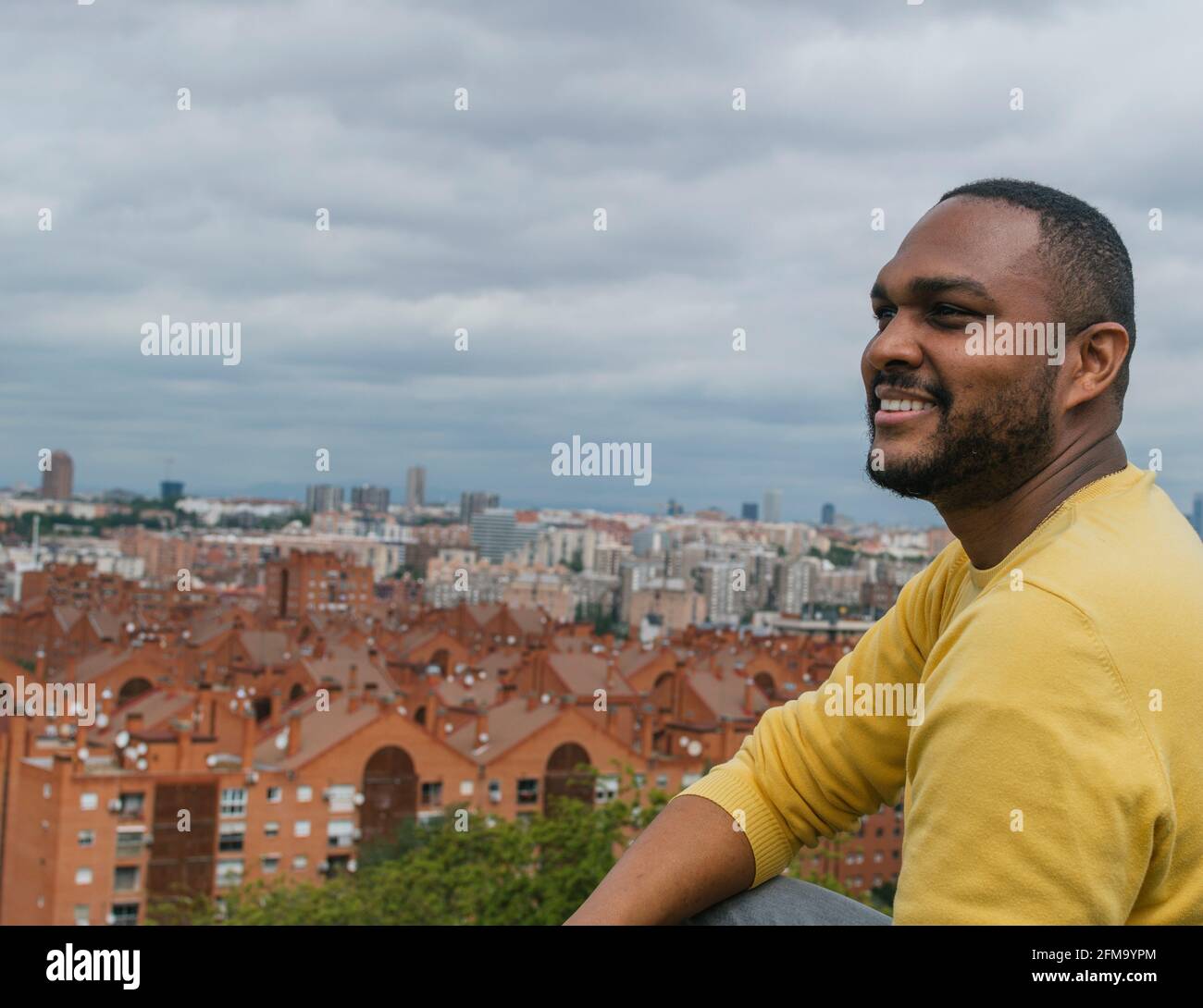 Black man looking at the horizon in a park Stock Photo - Alamy