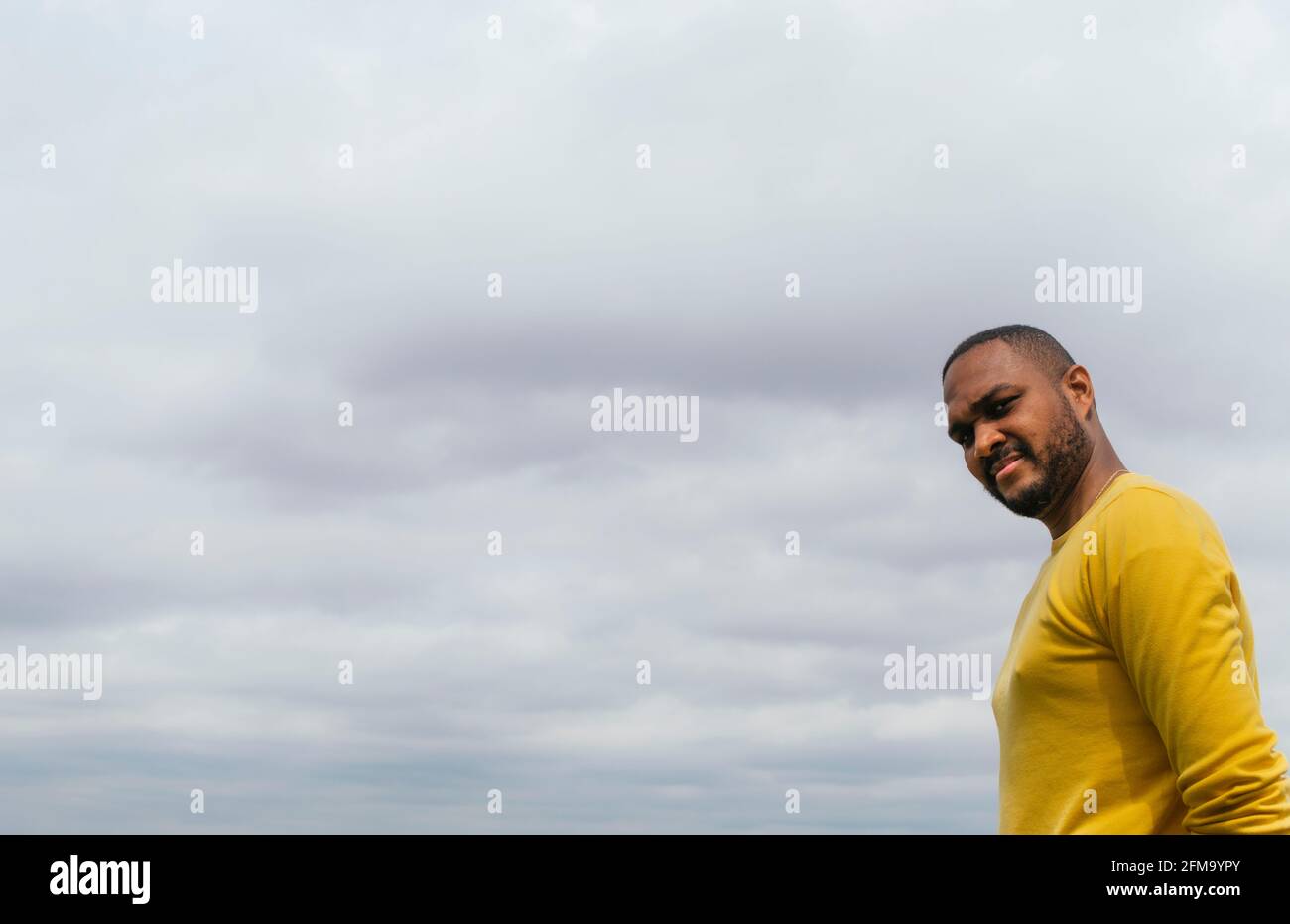 Black man looking at the horizon in a park Stock Photo - Alamy