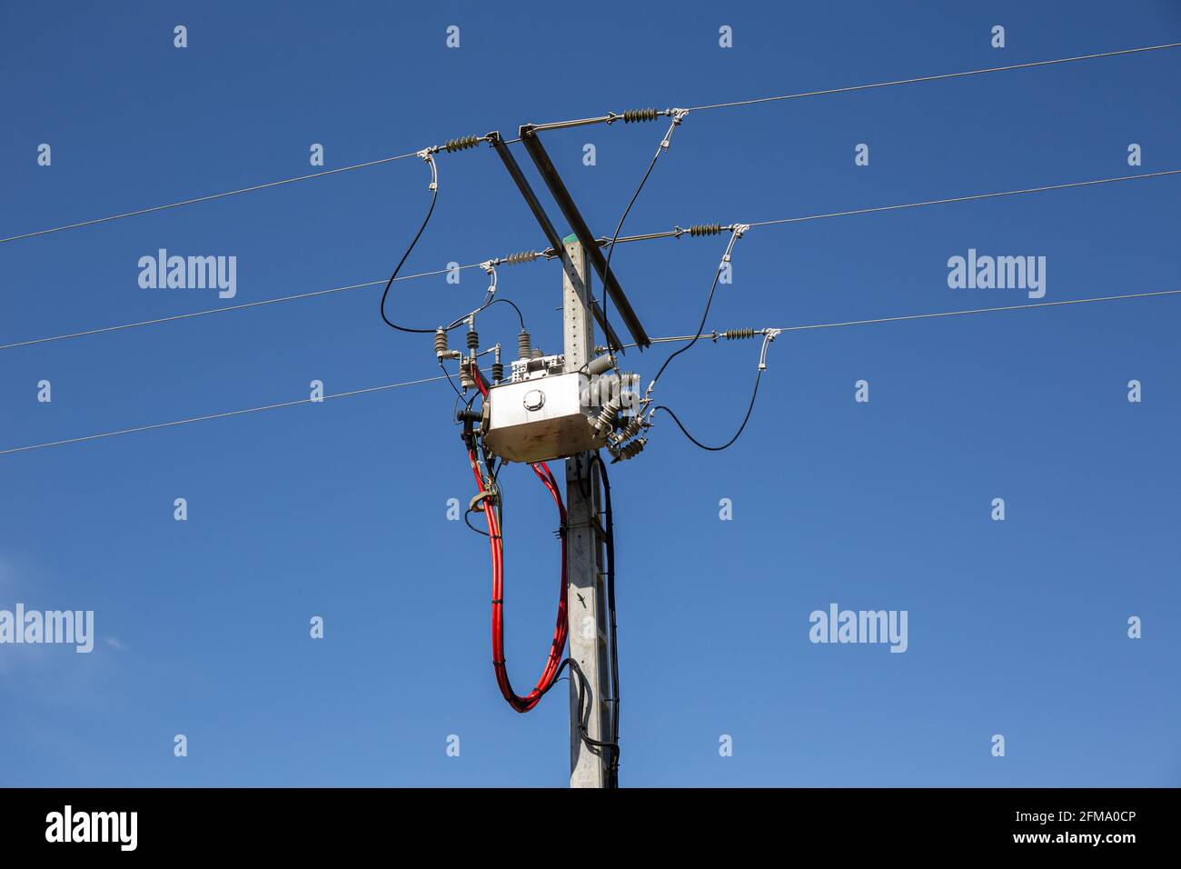 Electrical pylon with high voltage transformer on blue sky Stock Photo ...