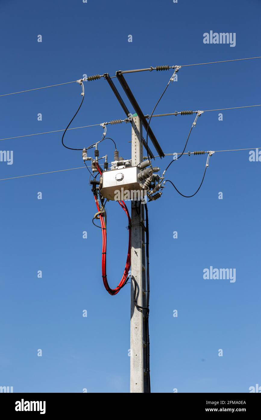 Electrical pylon with high voltage transformer on blue sky Stock Photo ...