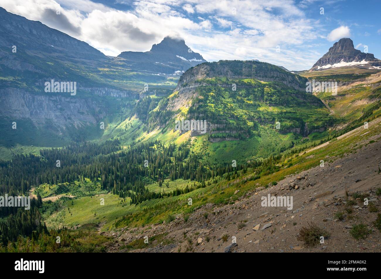 Morning sun lits the Heavy Runner Mountain and surrounding peaks along ...