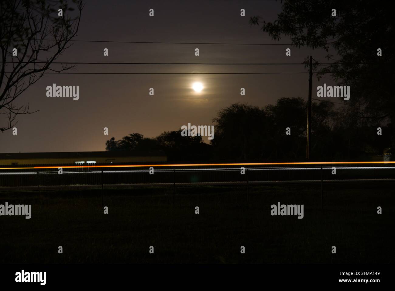 Long exposure of car lights on a road during nighttime Stock Photo - Alamy
