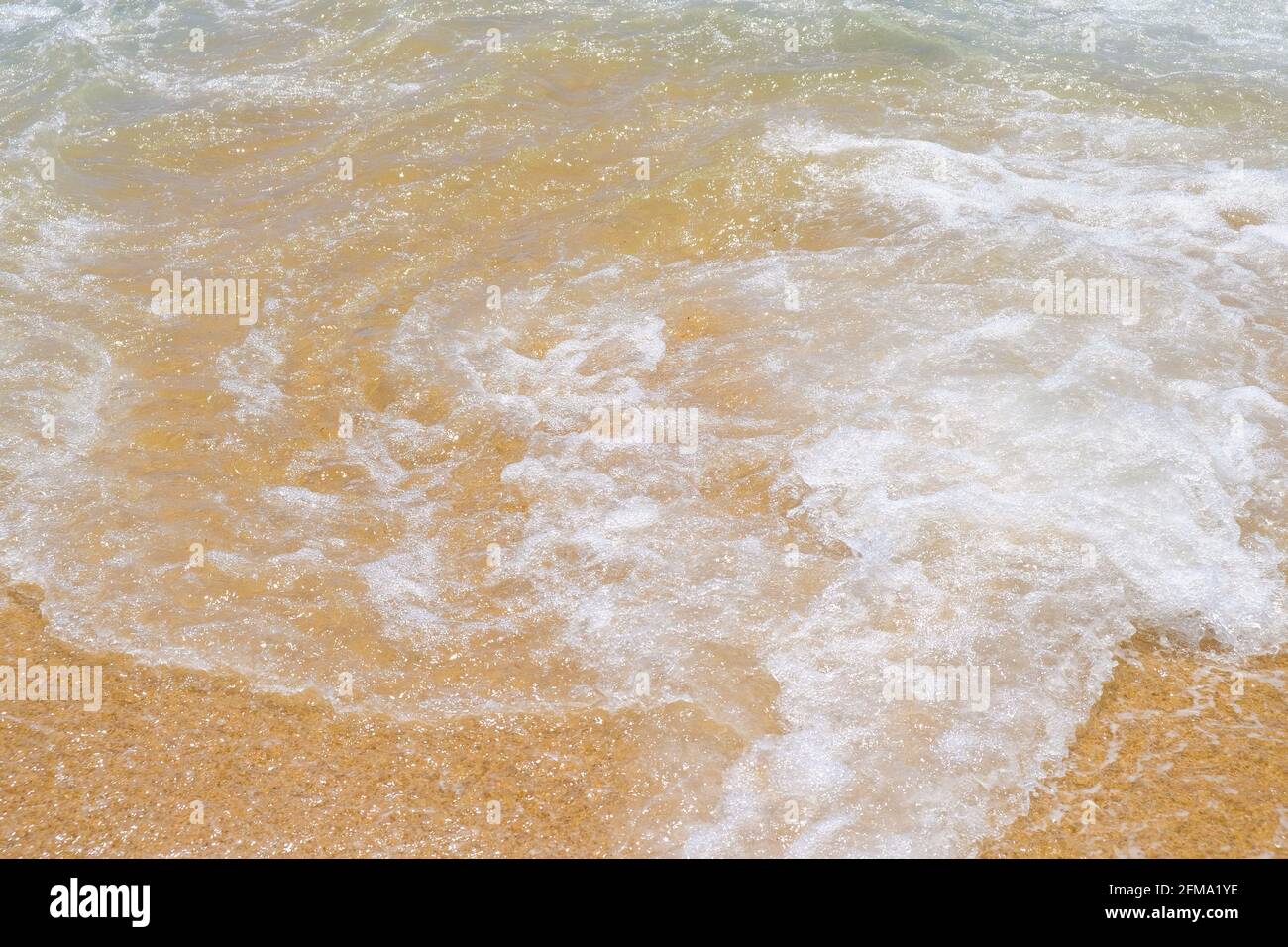 Wave on wet beach sand. The clear water and sand on Mediterranean Sea ...