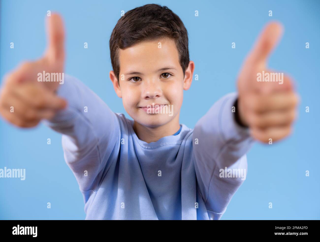 Like! Portrait of happy little boy in blue sweater smiling at camera ...