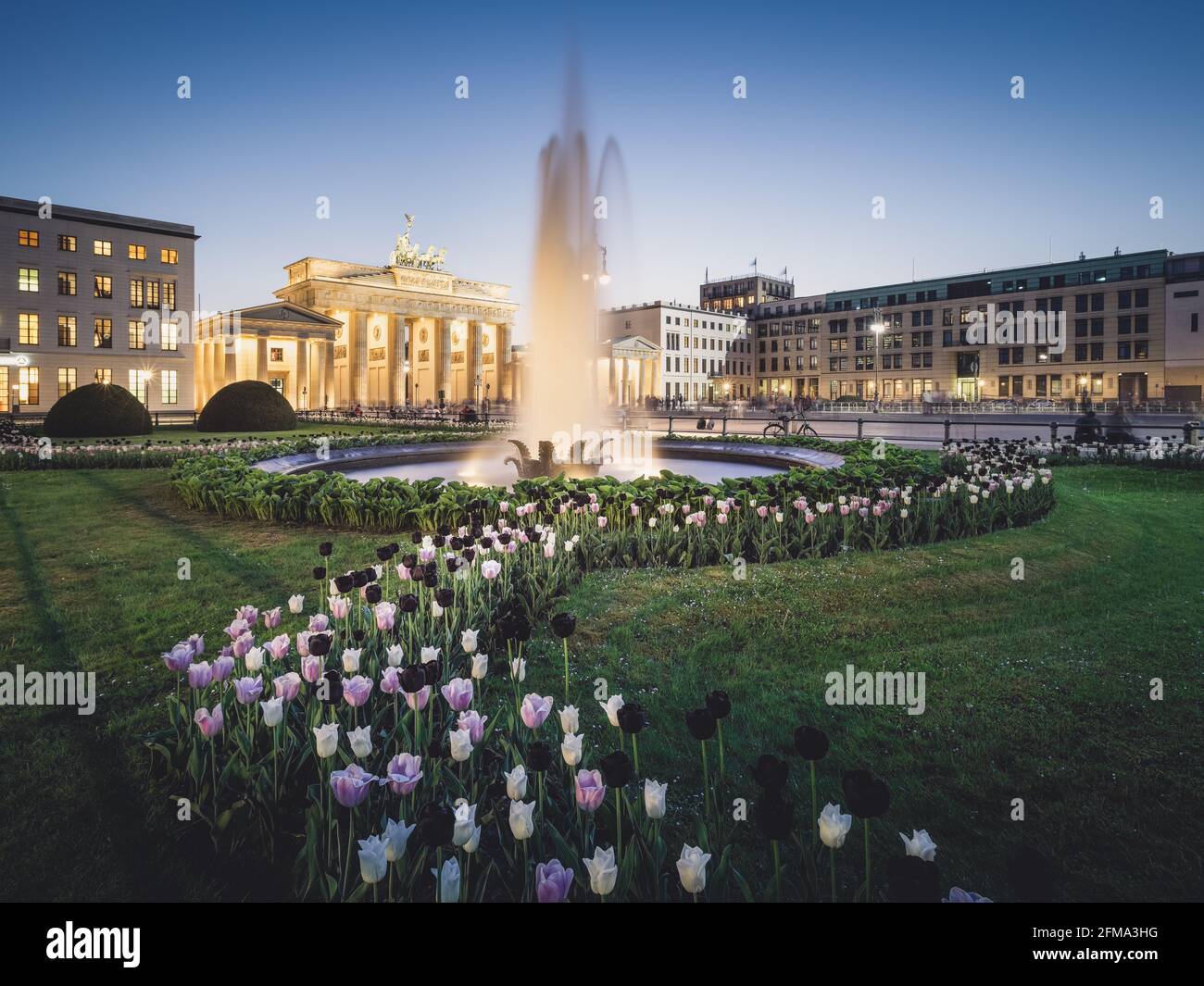 Spring at the fountain of Pariser Platz with Brandenburg Gate in the ...