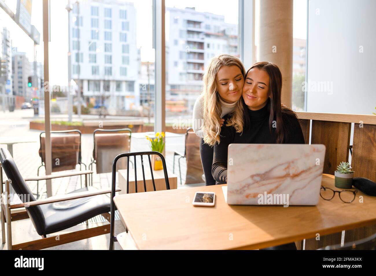 Close Friends Greeting At Cafe During Schoolwork Stock Photo - Alamy