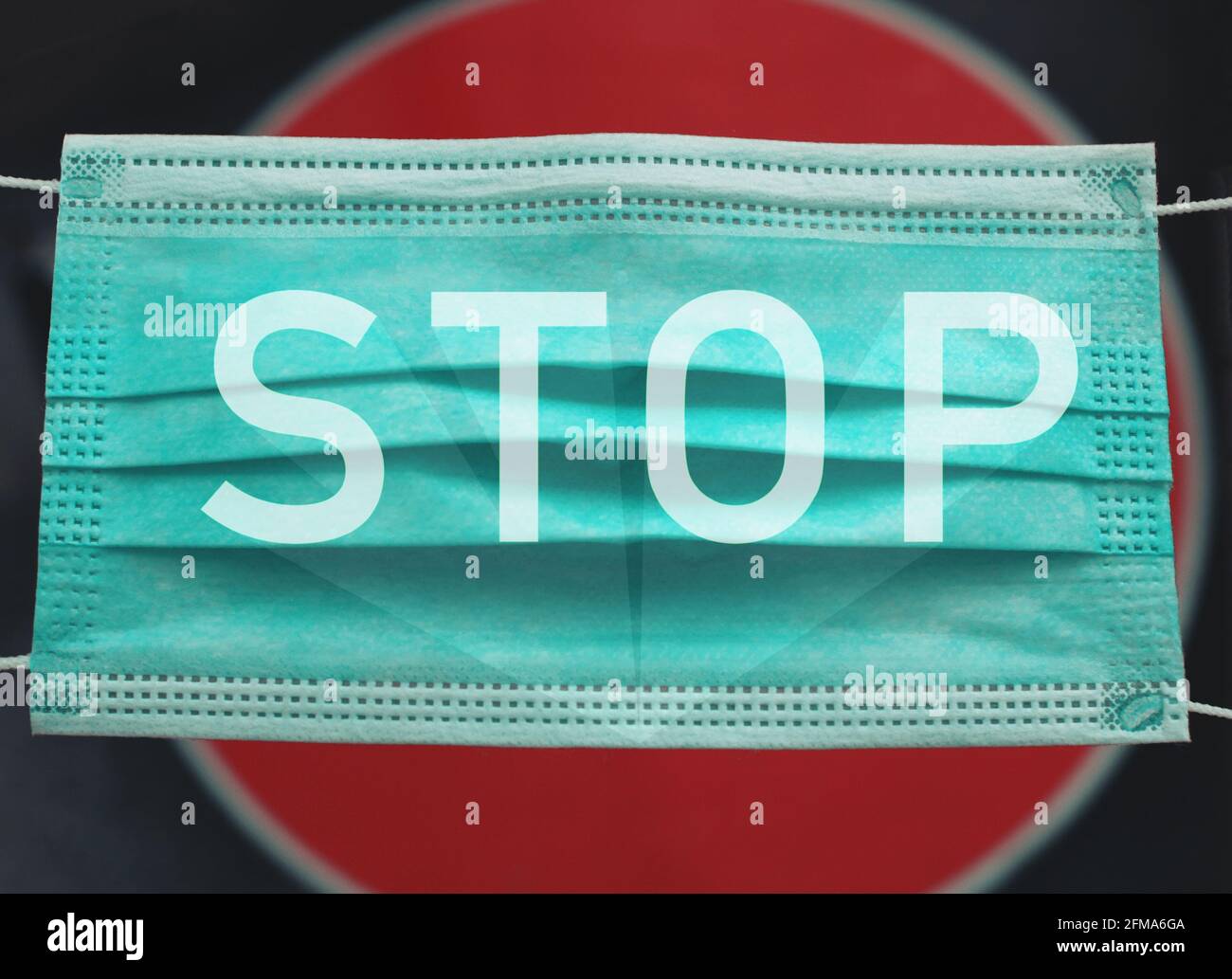 Surgical mask with the text "stop" with the stop sign as background ...