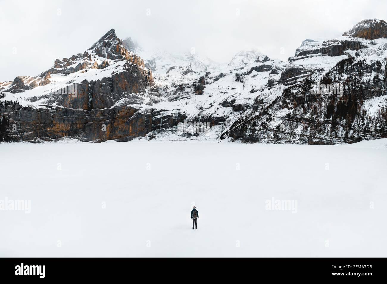 Individual hikers on the frozen Oeschinensee with a view of the ...