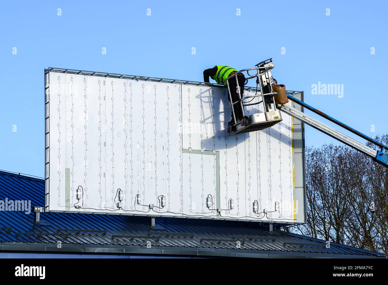 installation of a new large modern billboard with LED lighting on a ...