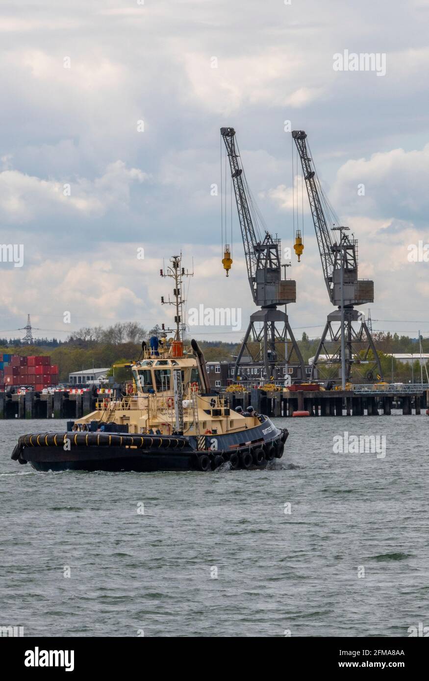 a tug underway in the port of southampton docks ready to assist in ...