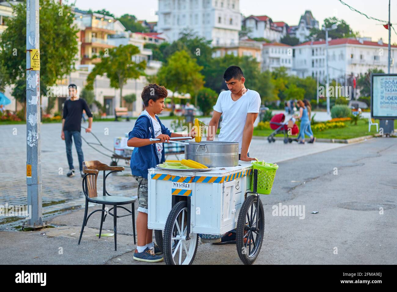 A Turkish boy sells boiled corn on the street. Istanbul, Turkey - 28.07 ...