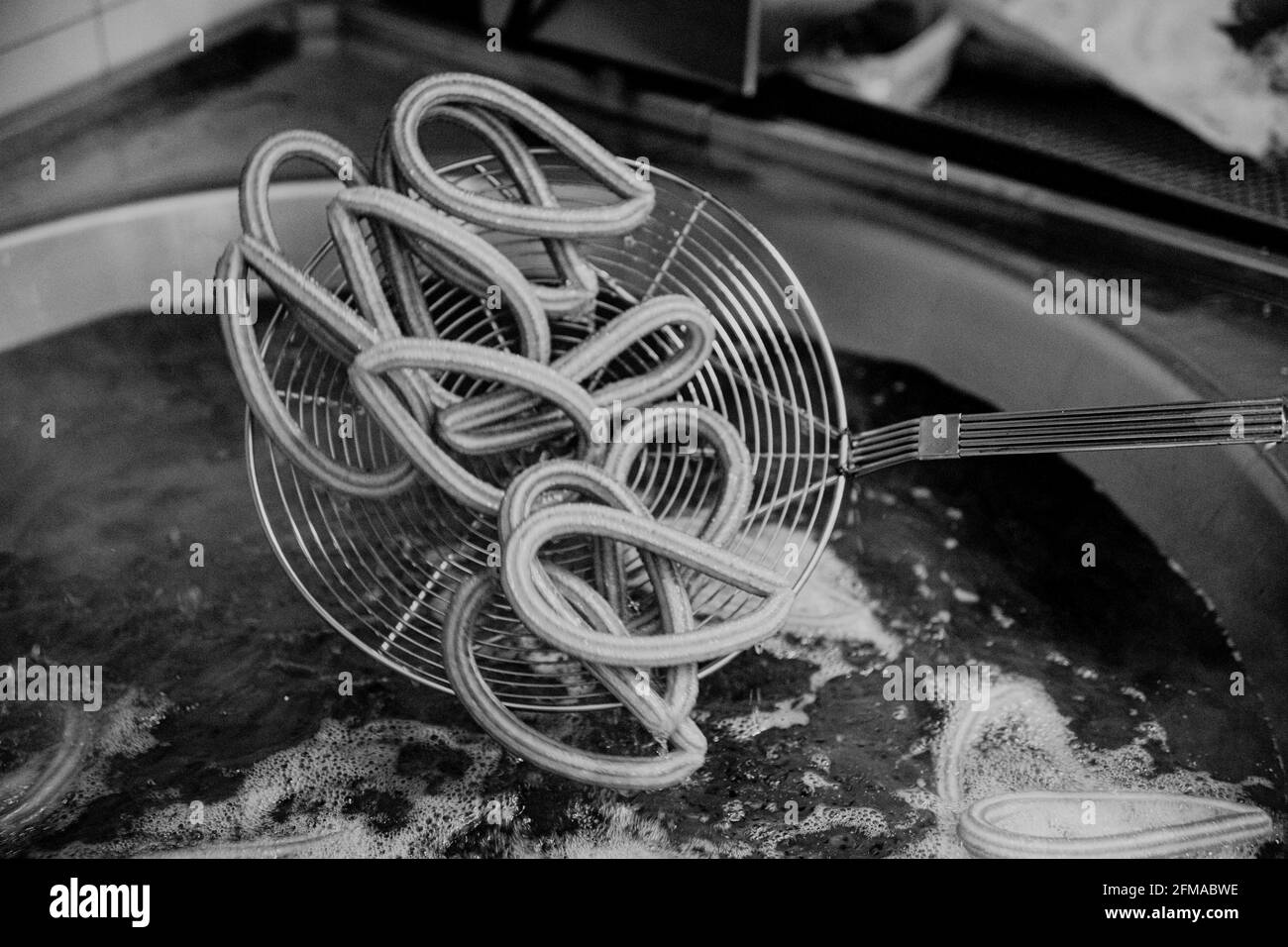 Grayscale shot of churro preparation Stock Photo - Alamy