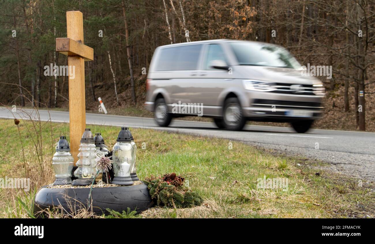 A roadside memorial cross with a candles commemorating the tragic death ...