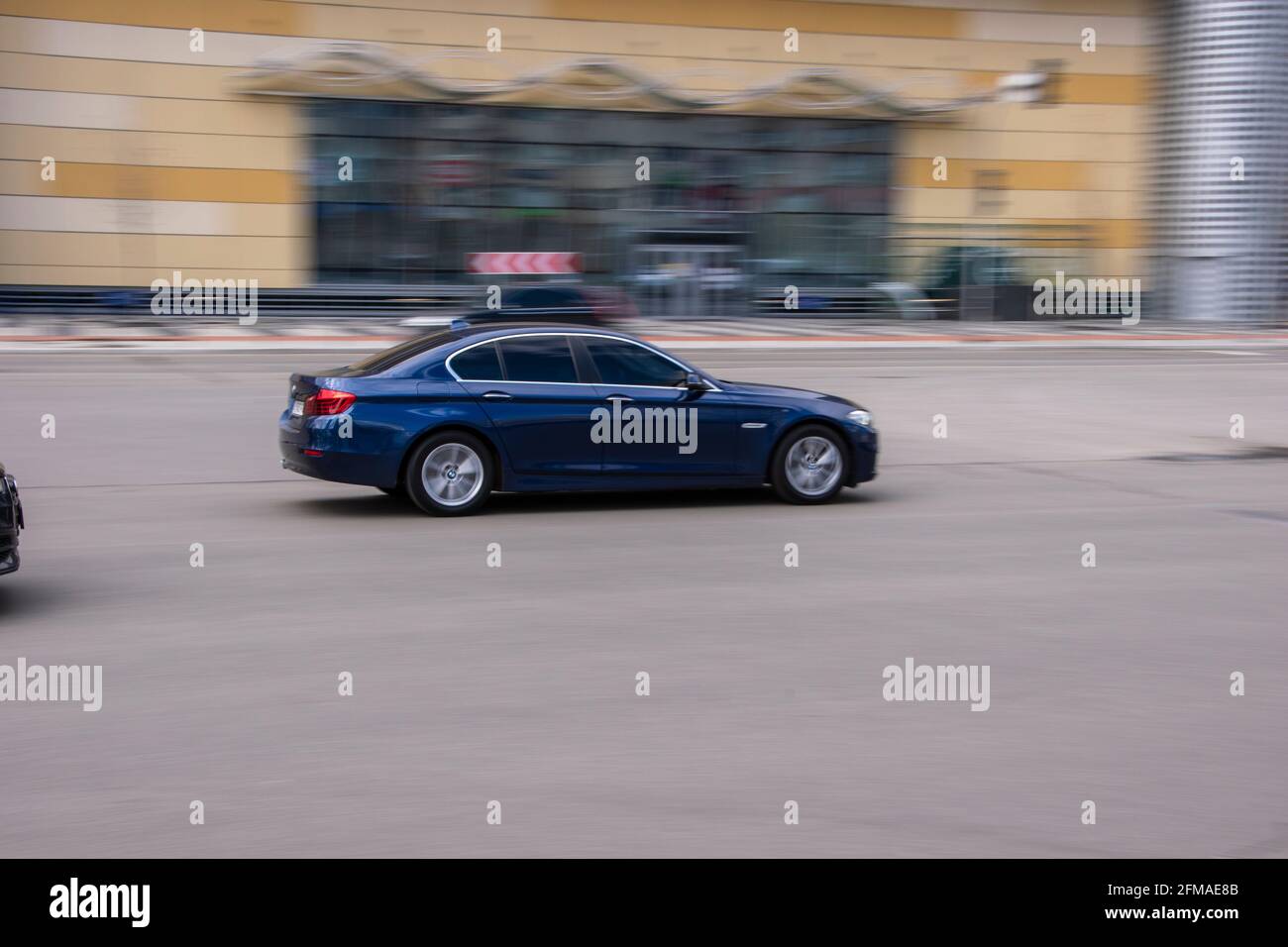 Ukraine, Kyiv - 26 April 2021: Blue BMW 5 Series car moving on the ...