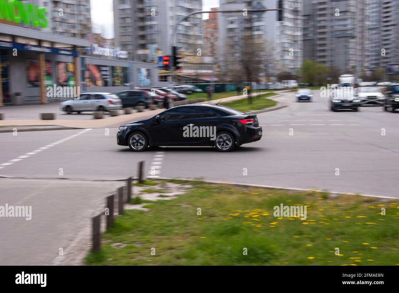 Ukraine, Kyiv - 26 April 2021: Black KIA Cerato car moving on the ...