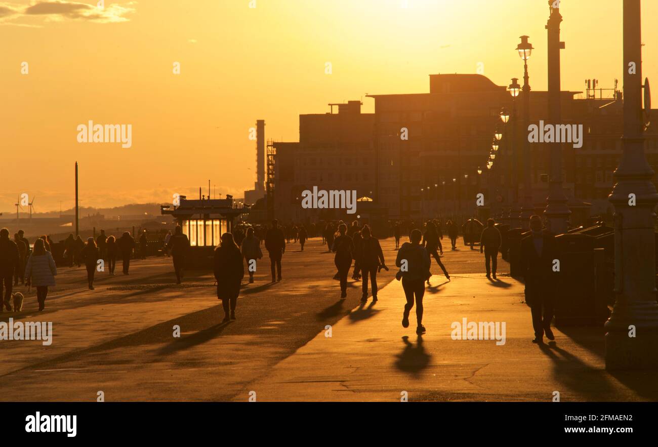 Silhouetted shapes of people on Hove Promenade. Brighton & Hove, Sussex ...