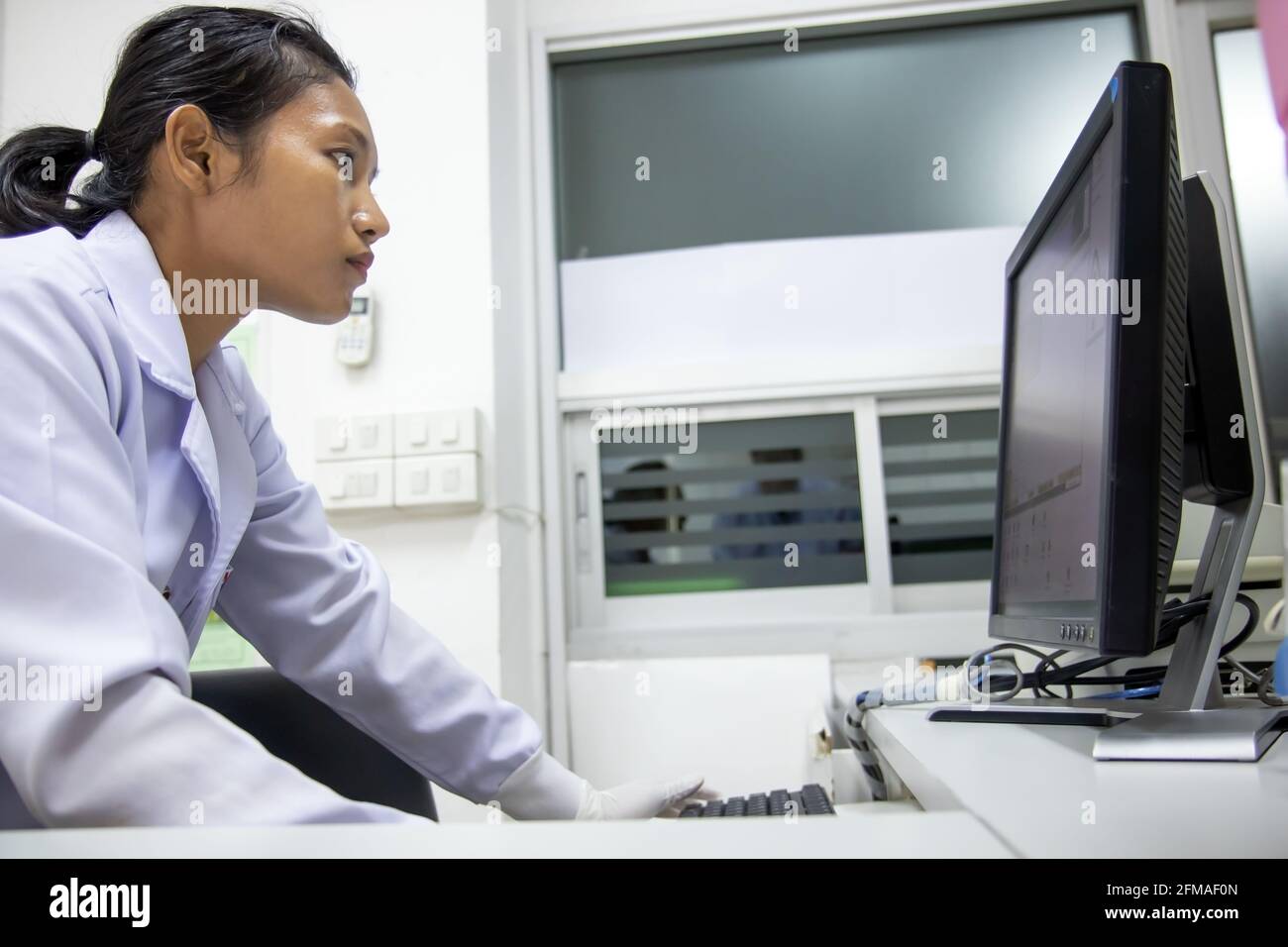 Medical staff checks registration on computer display. Night shifts ...