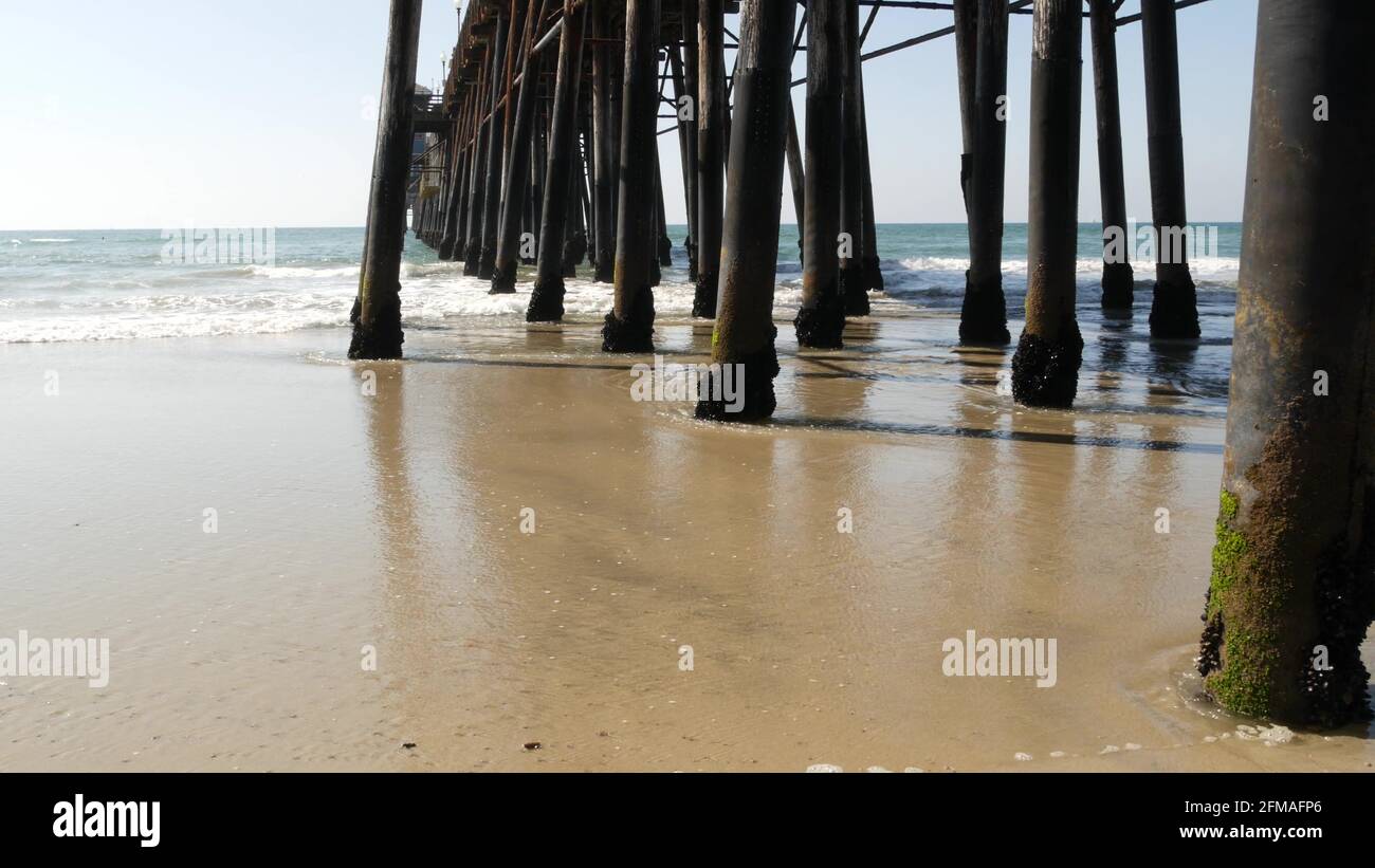 Wooden piles under boardwalk, old pier in Oceanside, California coast ...
