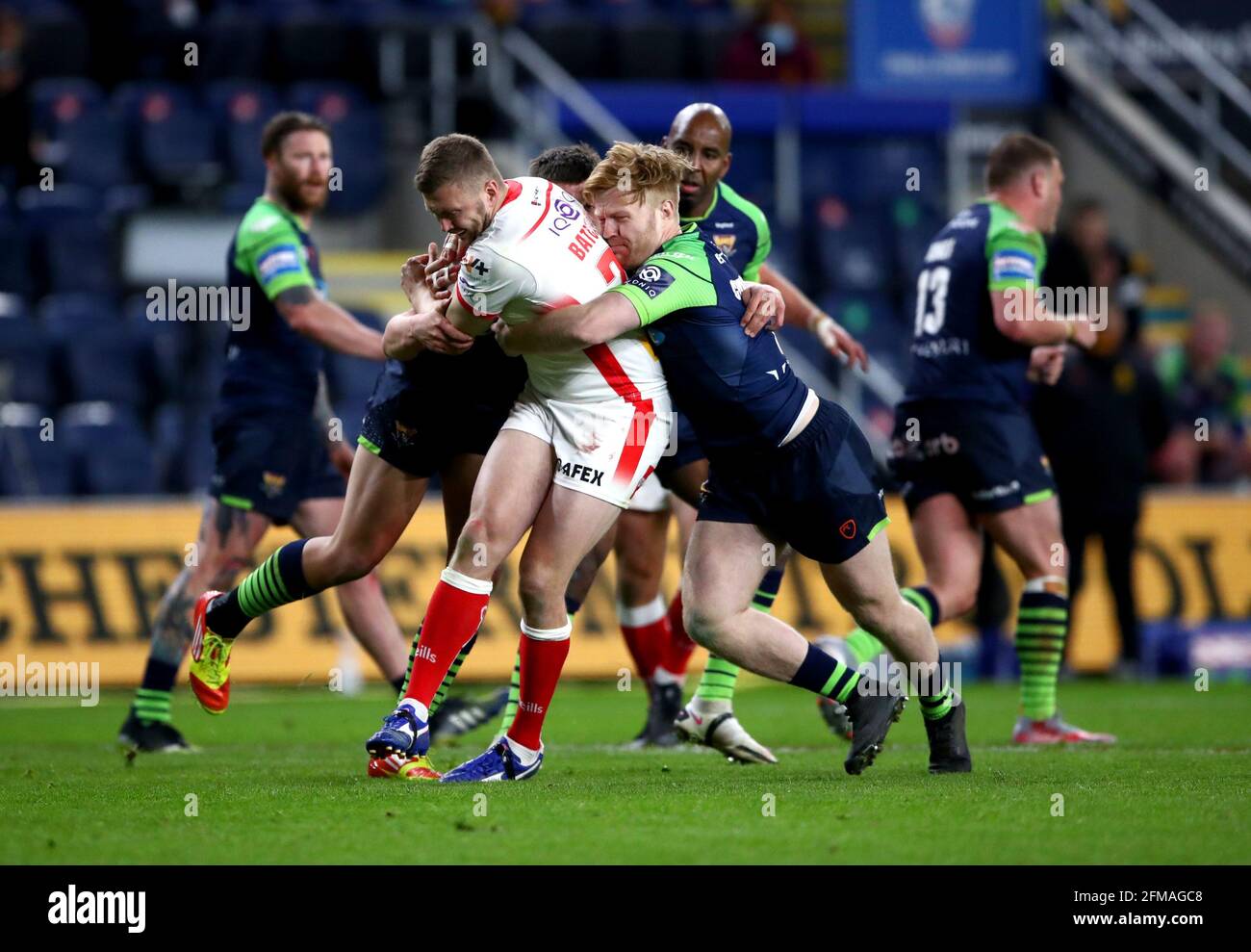 St Helens' Joe Batchelor is tackled by Huddersfield Giants' James ...