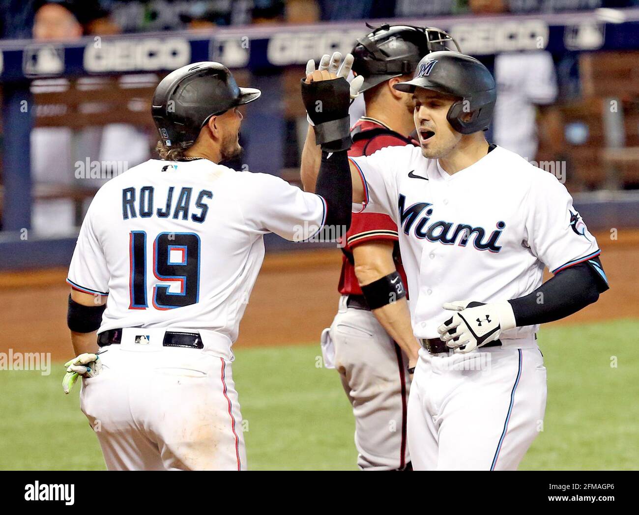 Miami Marlins' Miguel Rojas (19) waits for Adam Duvall (14) after ...