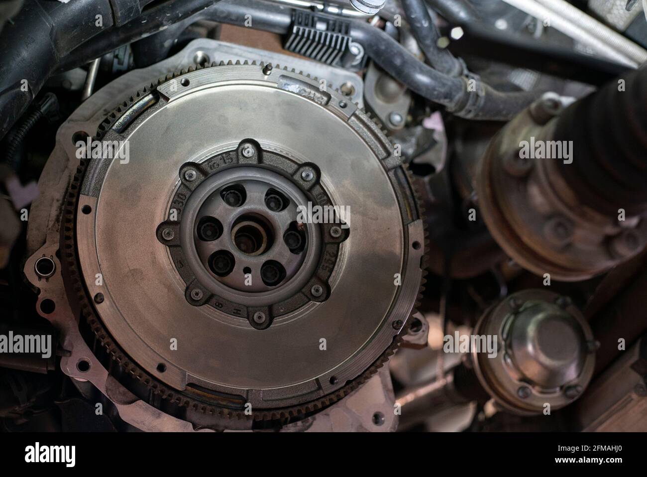 Detail of Car flywheel assembly in a workshop, car reparation engine ...