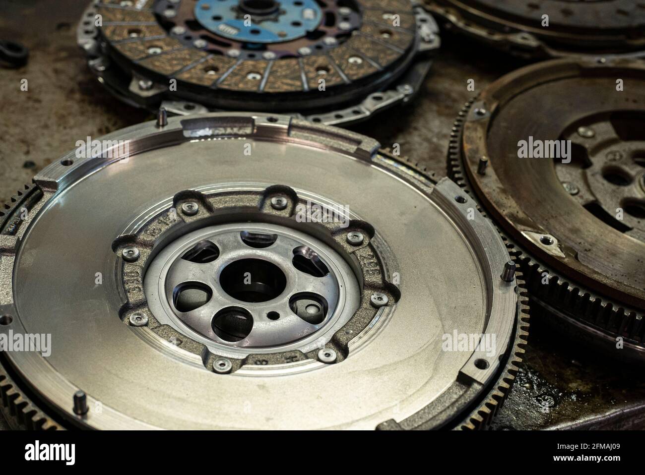 Detail of Car flywheel in a workshop, car spare parts old and new Stock ...