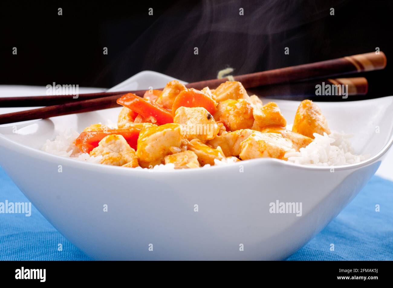 indian butter chicken over white rice Stock Photo - Alamy