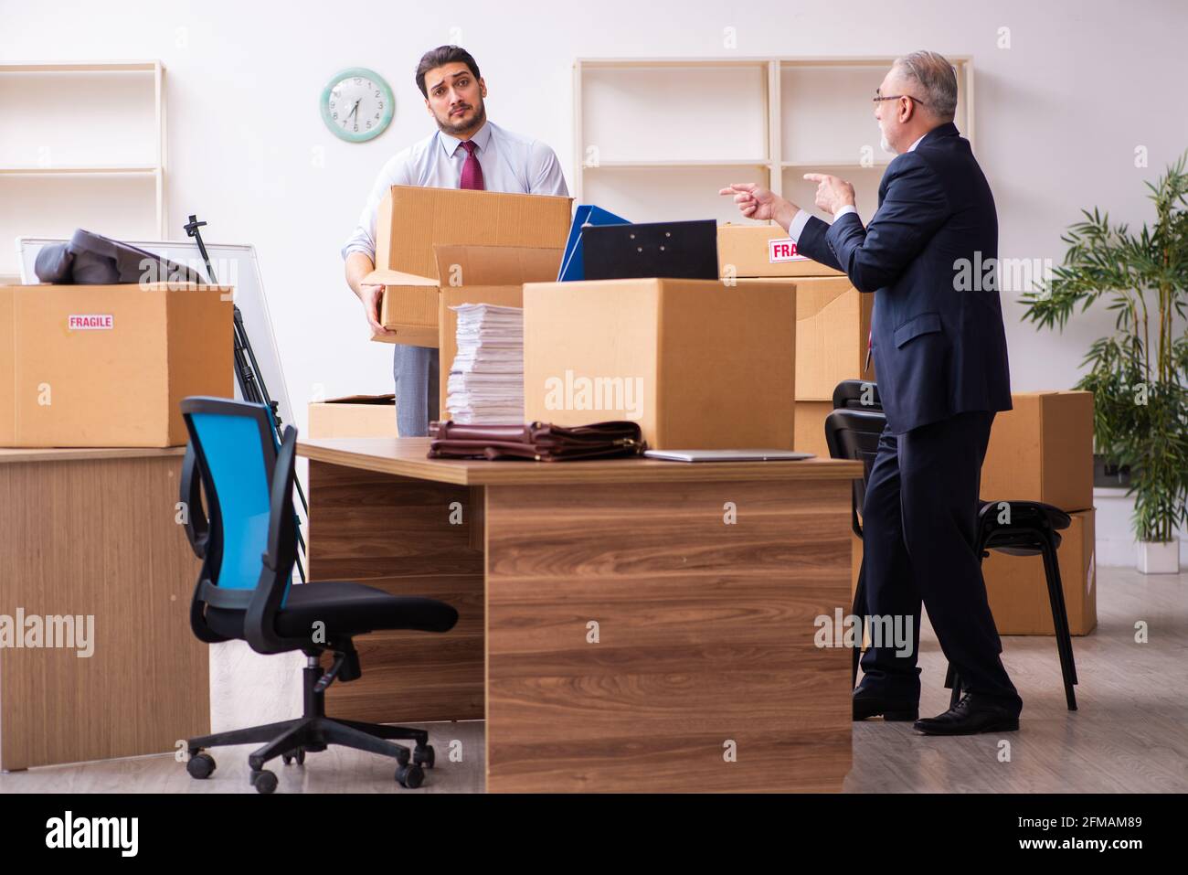 Two employees in relocation concept Stock Photo - Alamy