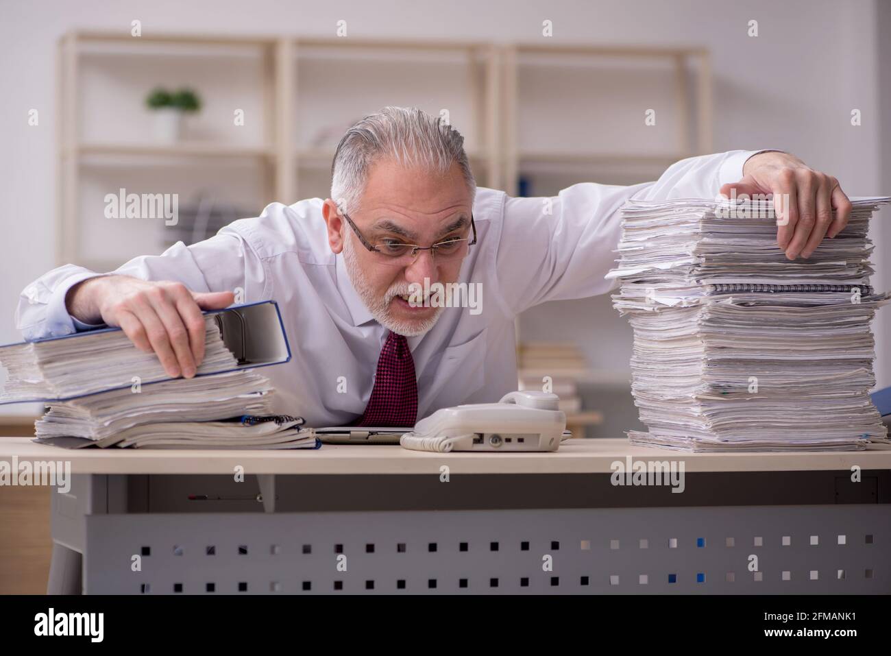 Experienced businessman employee and too much work in the office Stock ...