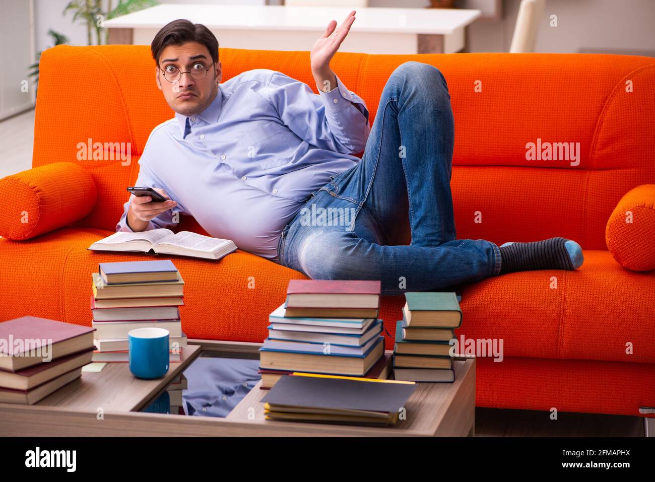 Young student preparing for exams at home Stock Photo - Alamy
