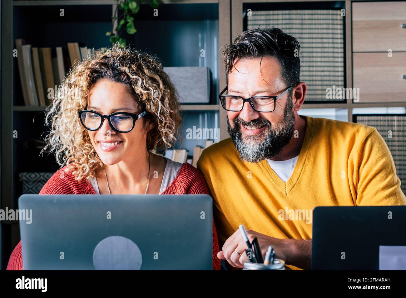 Happy man and woman couple work at home in smart working office ...