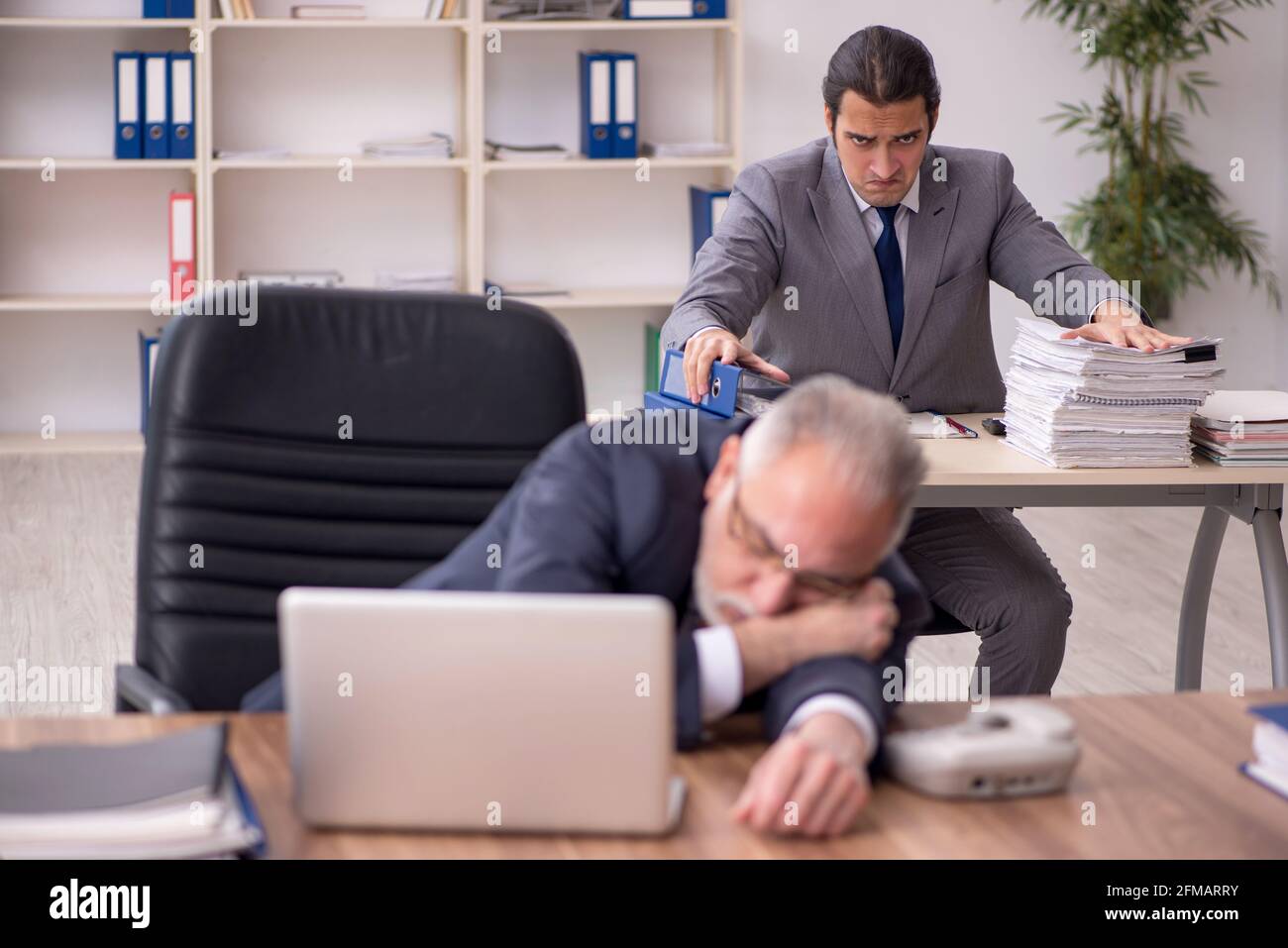 Bad teamwork tired manager sleep at work desk angry colleagues hi-res ...