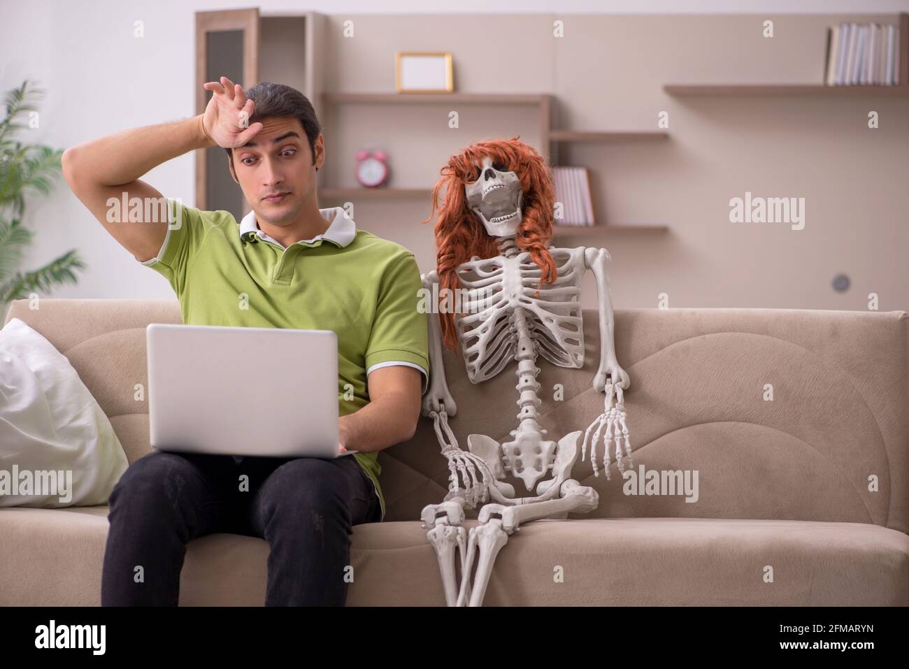 Human skeleton sitting with laptop computer hi-res stock photography ...