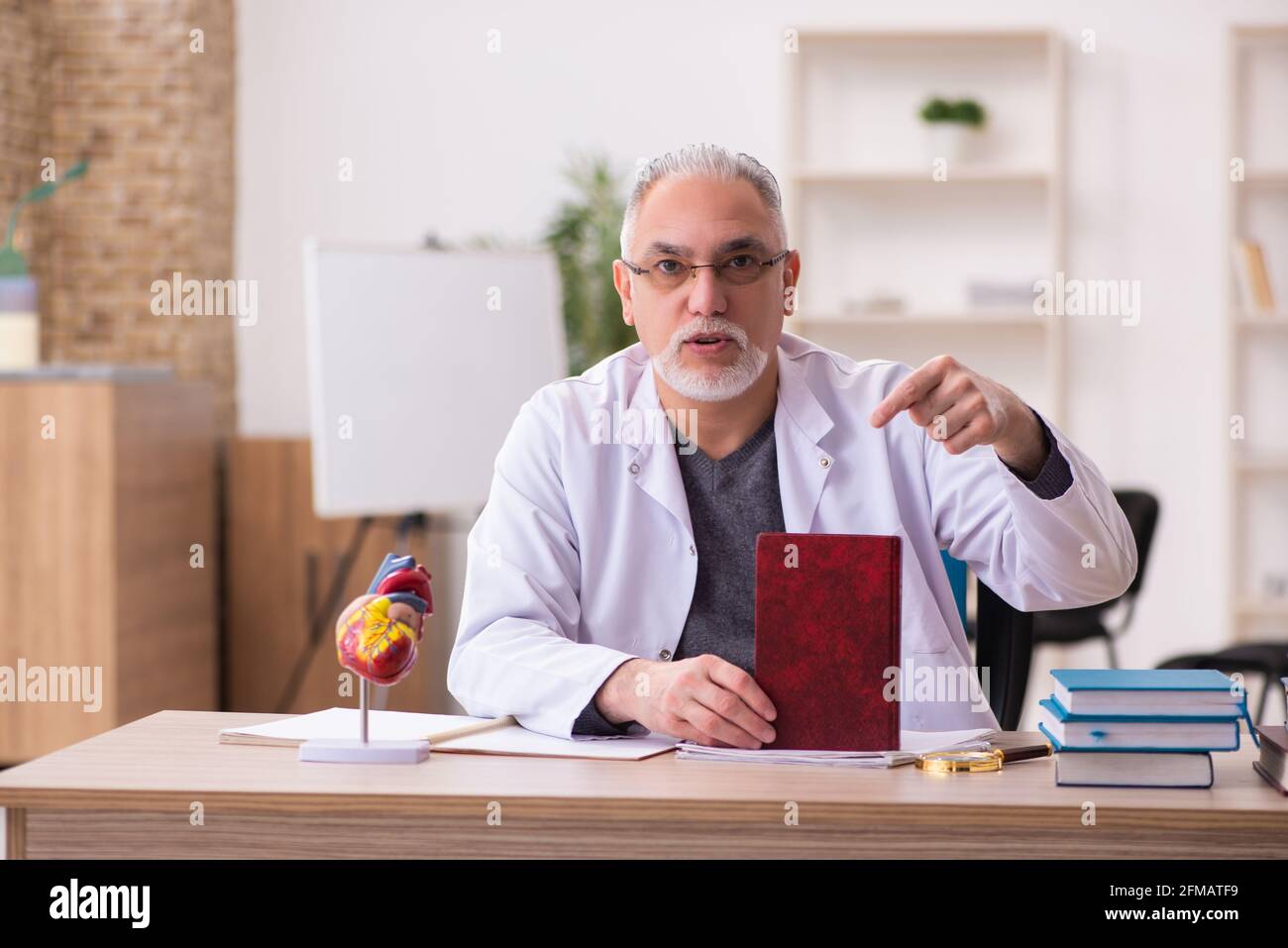 Old doctor cardiologist sitting in the classroom Stock Photo - Alamy